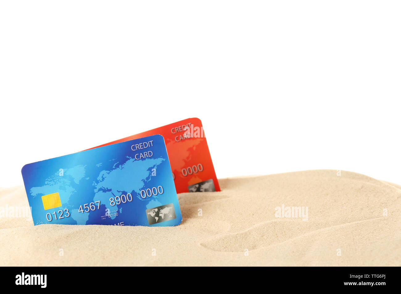 Red and blue bank cards in sand isolated on white Stock Photo - Alamy