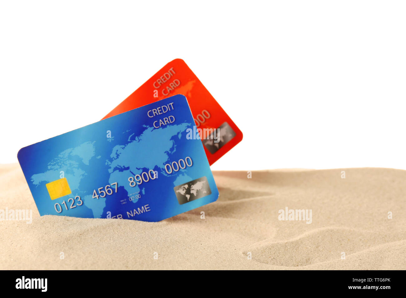 Red and blue bank cards in sand isolated on white Stock Photo - Alamy
