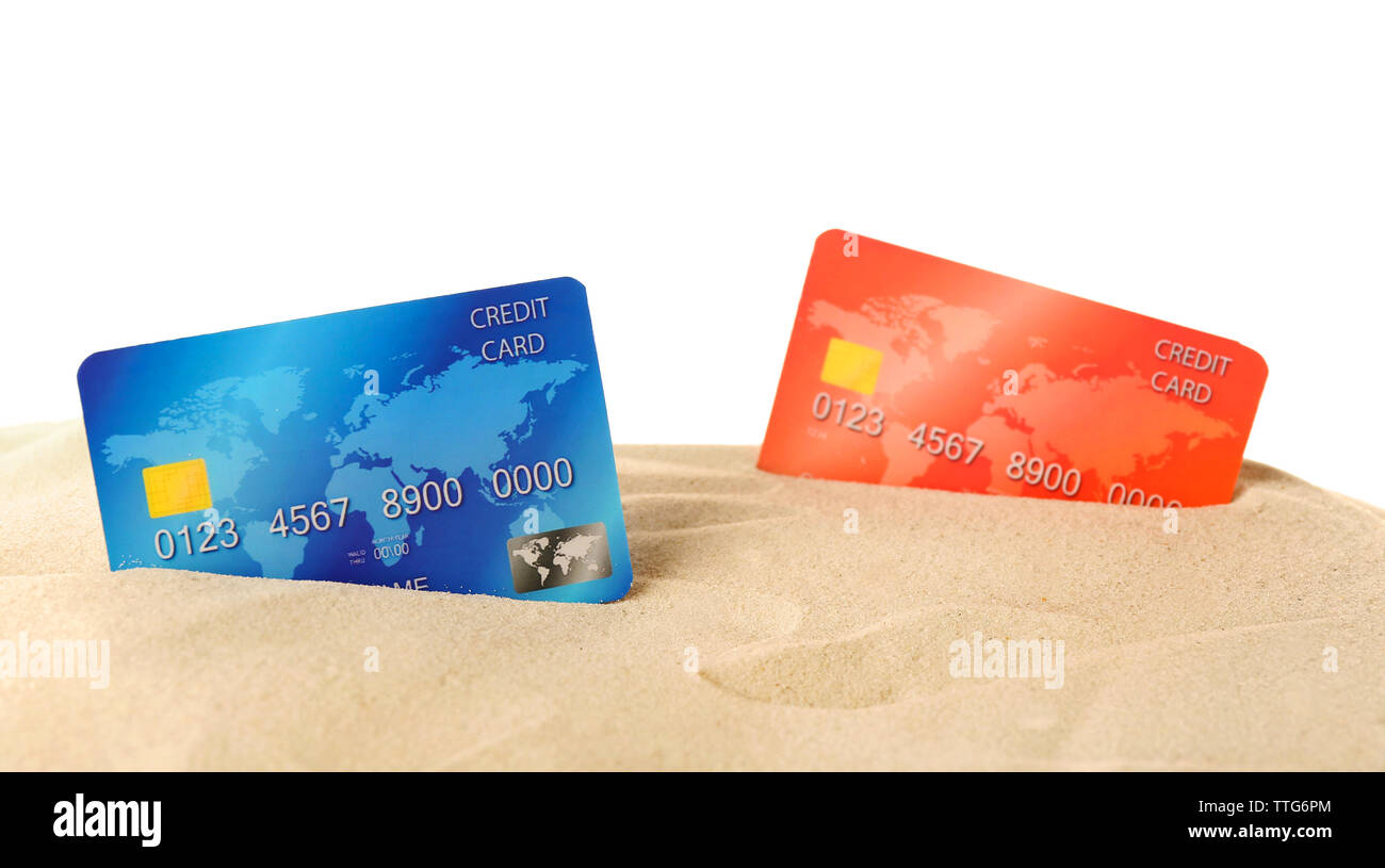 Red and blue bank cards in sand isolated on white Stock Photo - Alamy