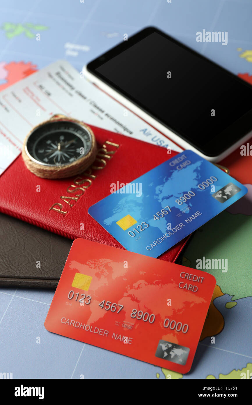 Credit cards with passports and tickets for vacations on the world map ...