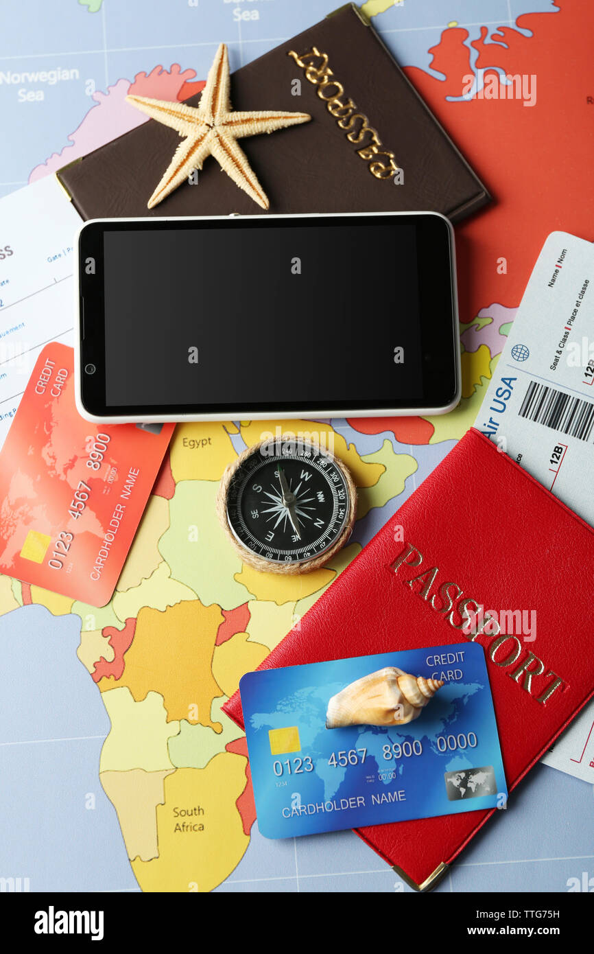 Credit cards with passports and tickets for vacations on the world map ...