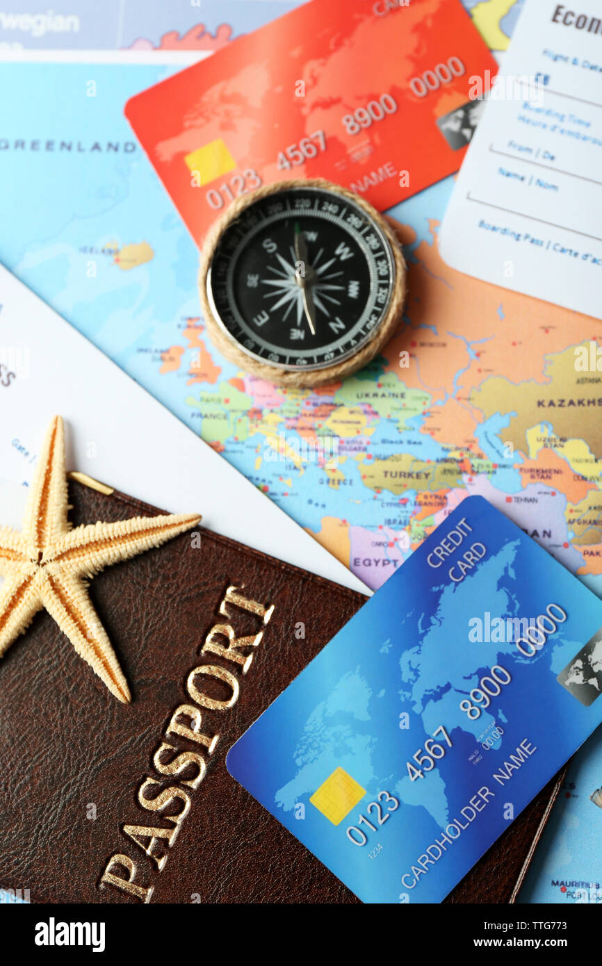 Credit cards with passports and tickets for vacations on the world map ...