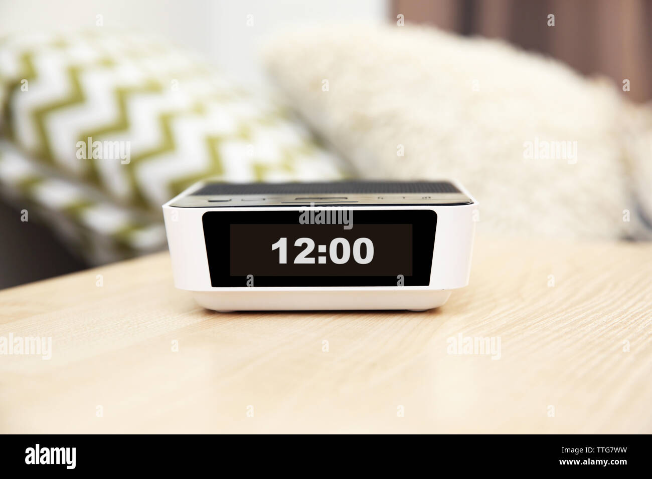 Digital clock on a bedside table in bedroom Stock Photo - Alamy