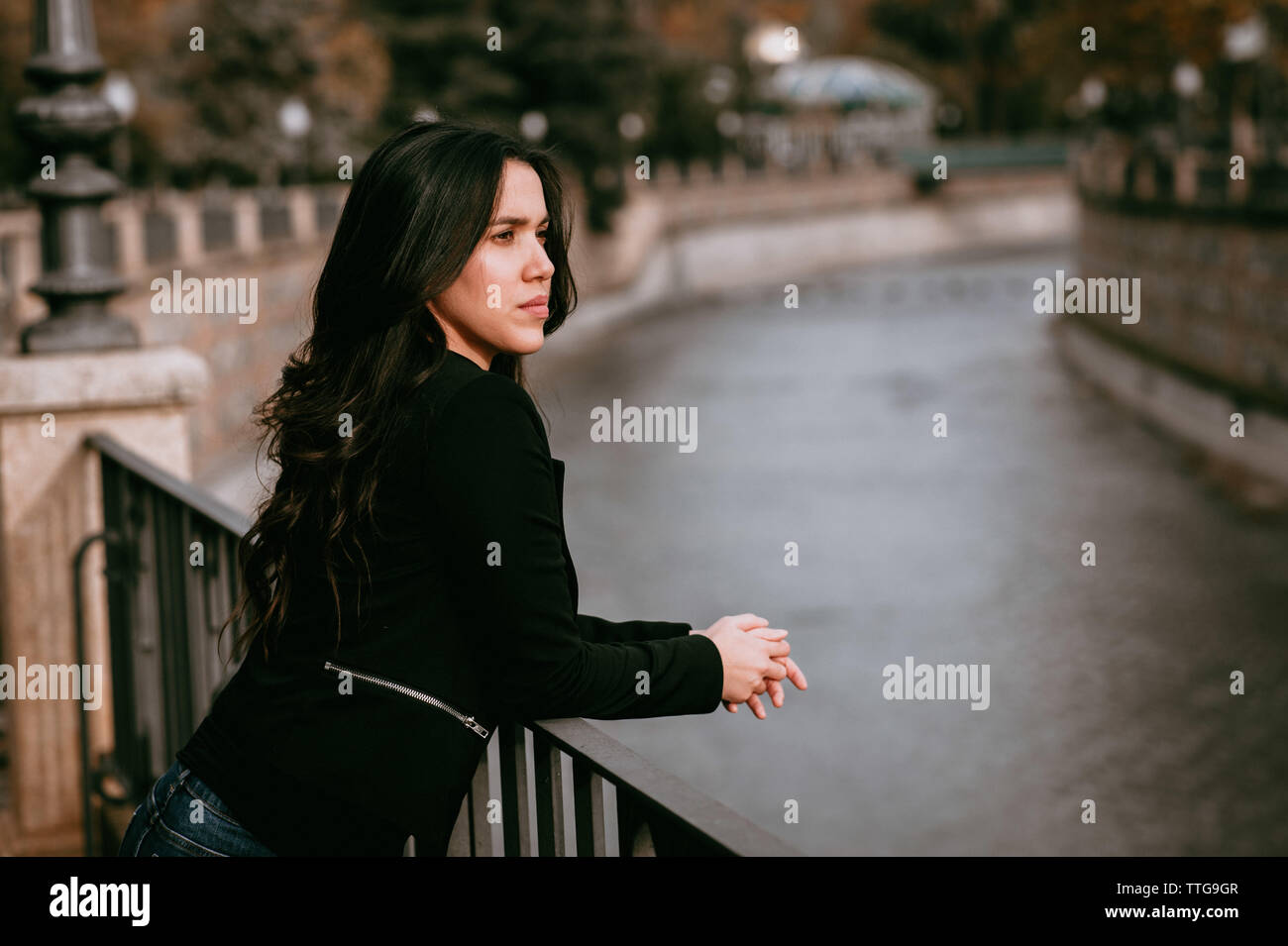 Thoughtful Woman on Bridge in Winter Stock Photo - Alamy