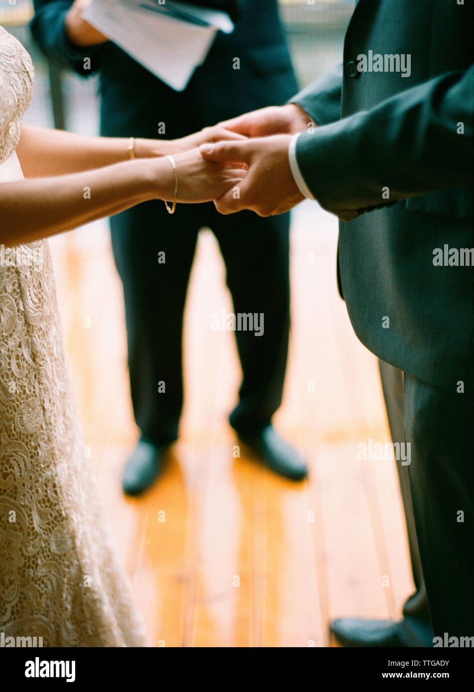 Bride and groom holding hands Stock Photo - Alamy