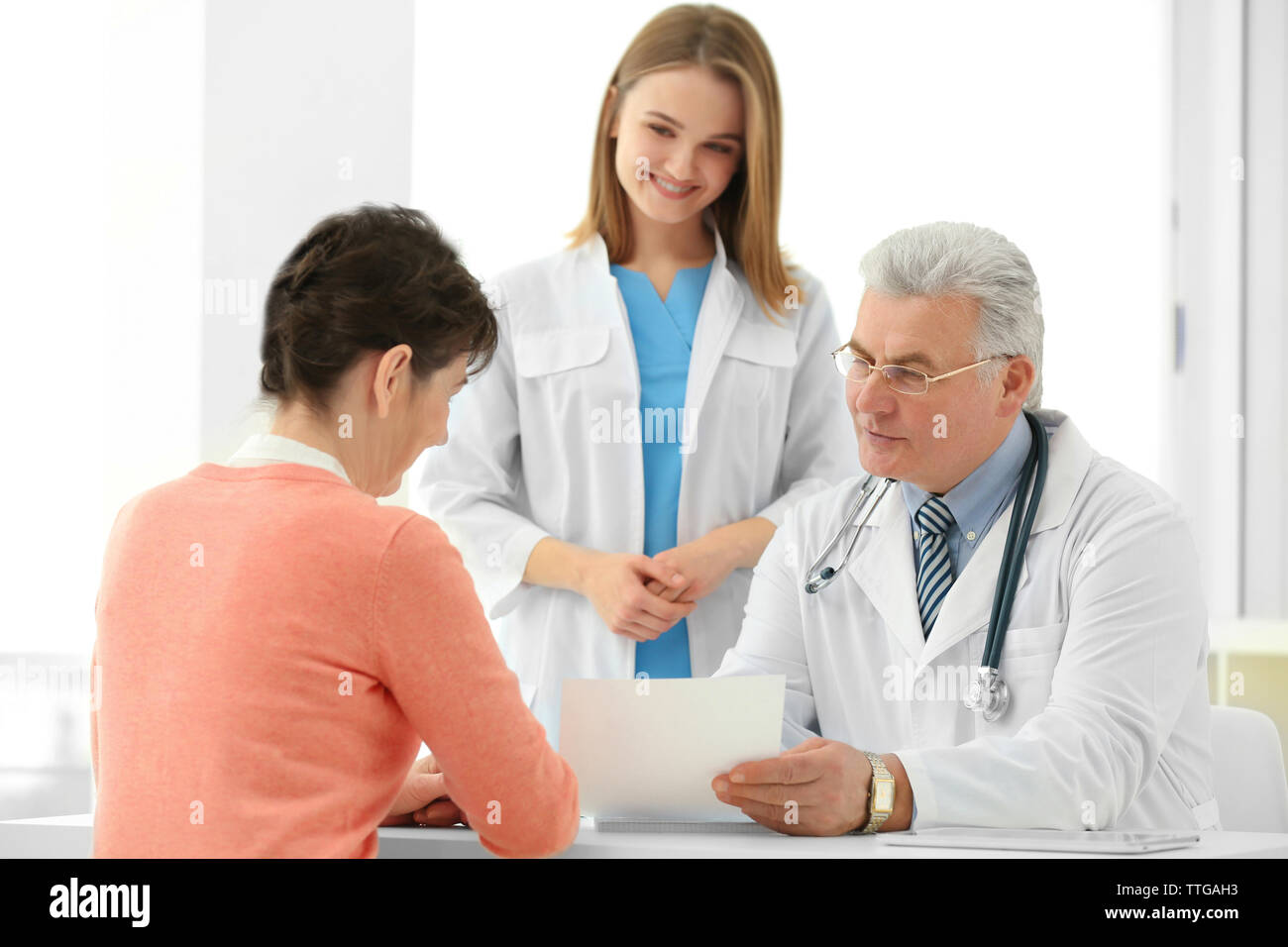 Doctor's office and patient and paper hi-res stock photography and ...