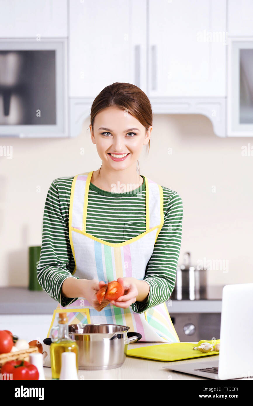 Young woman cooking in the kitchen Stock Photo - Alamy