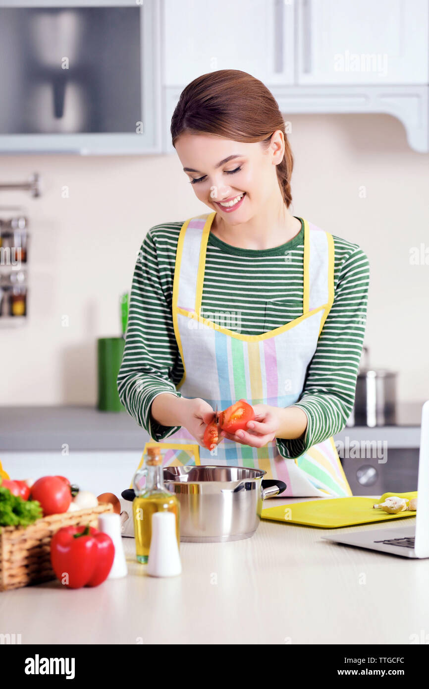 Young woman cooking in the kitchen Stock Photo - Alamy