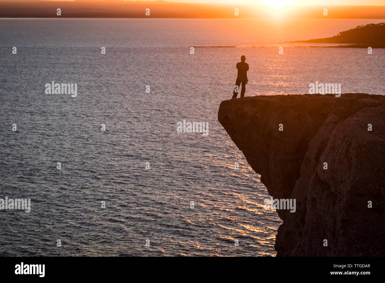 Lone Figure on Clifftop at Sunset Stock Photo - Alamy