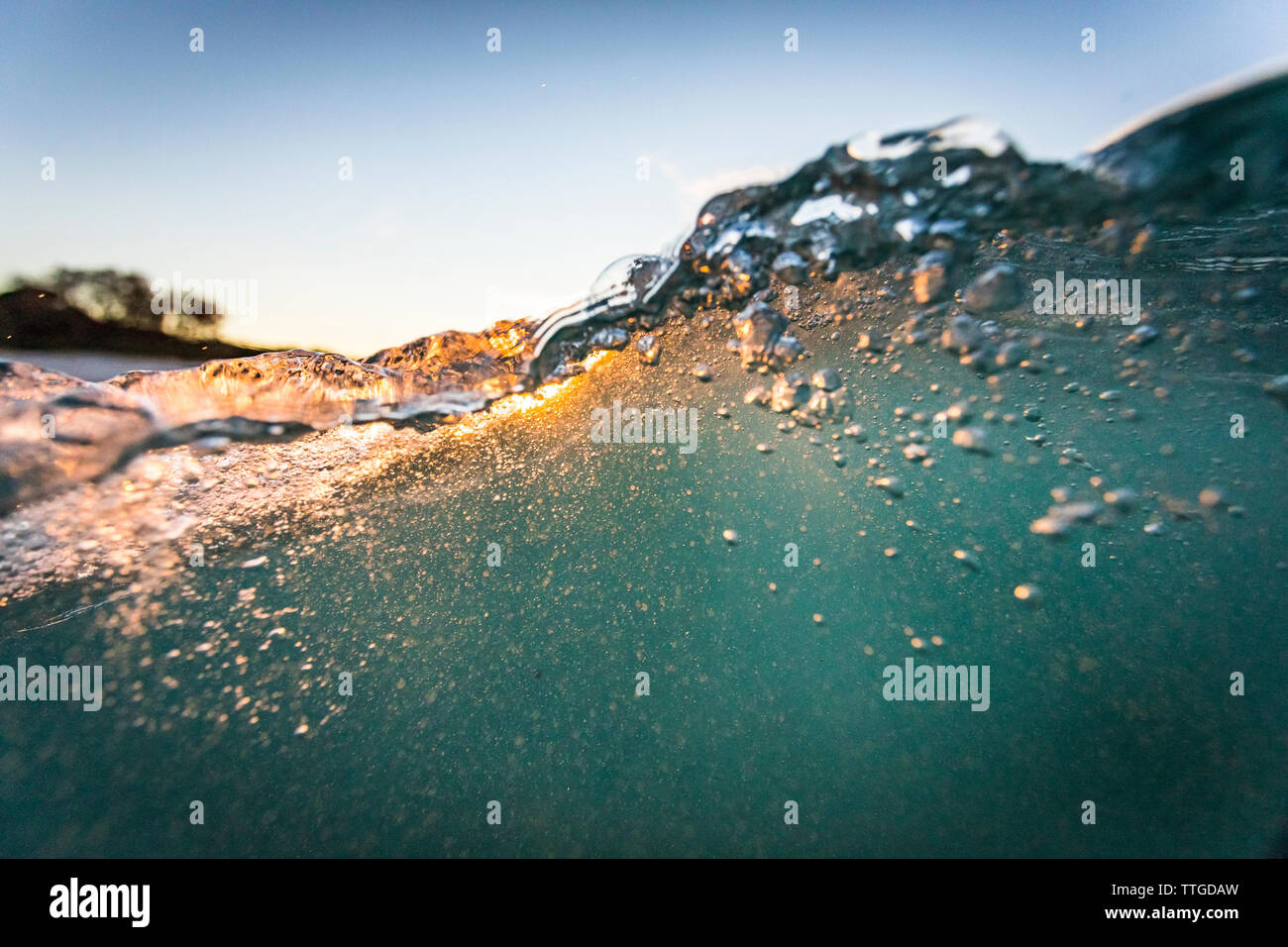 wave at sunrise Stock Photo - Alamy