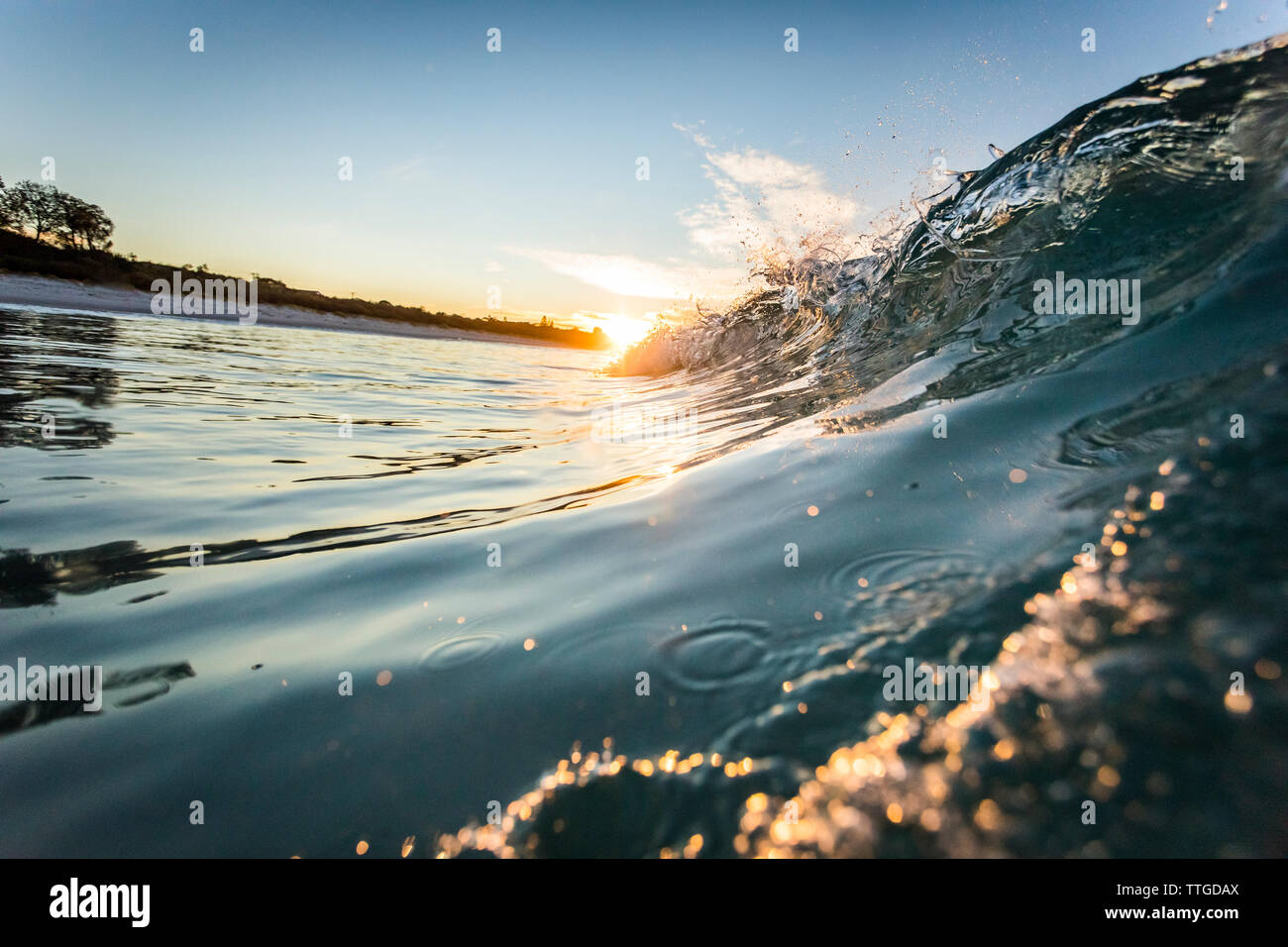wave at sunrise Stock Photo - Alamy