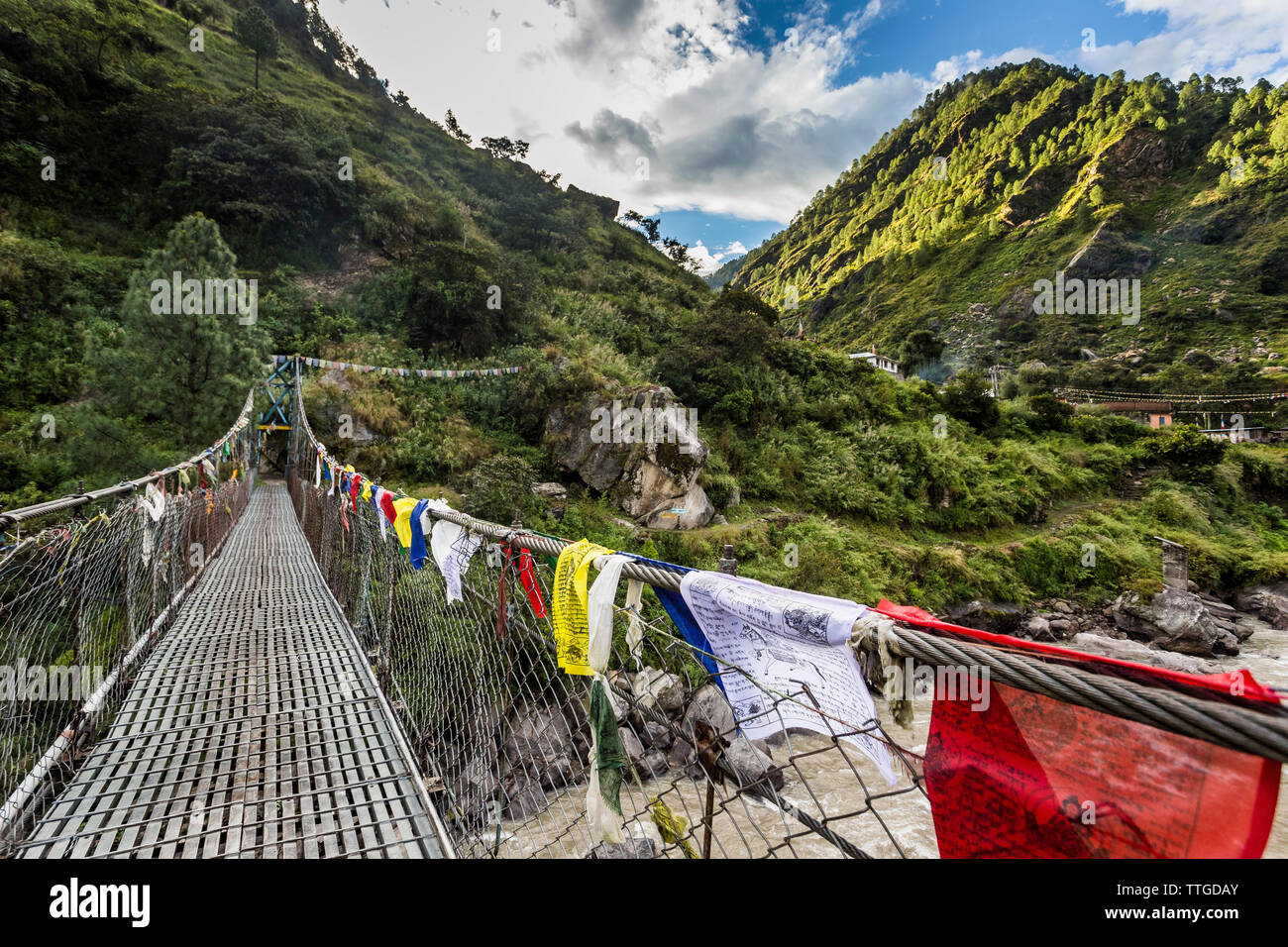 Mountain Valley with Prayer flags across bridge Stock Photo - Alamy