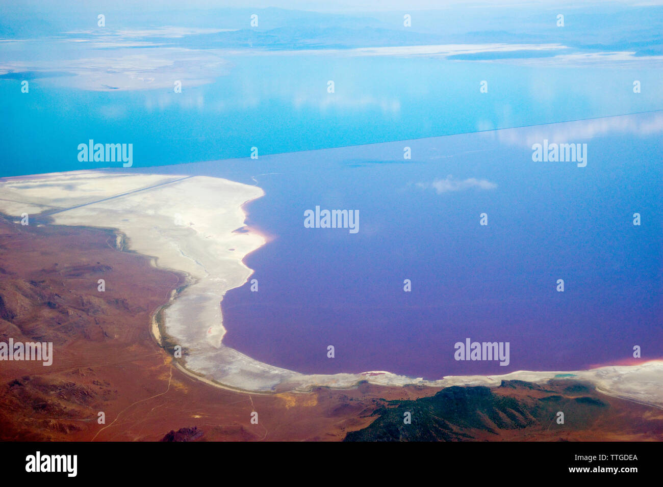 An aerial of a Reservoir with purple water and white beach Stock Photo ...