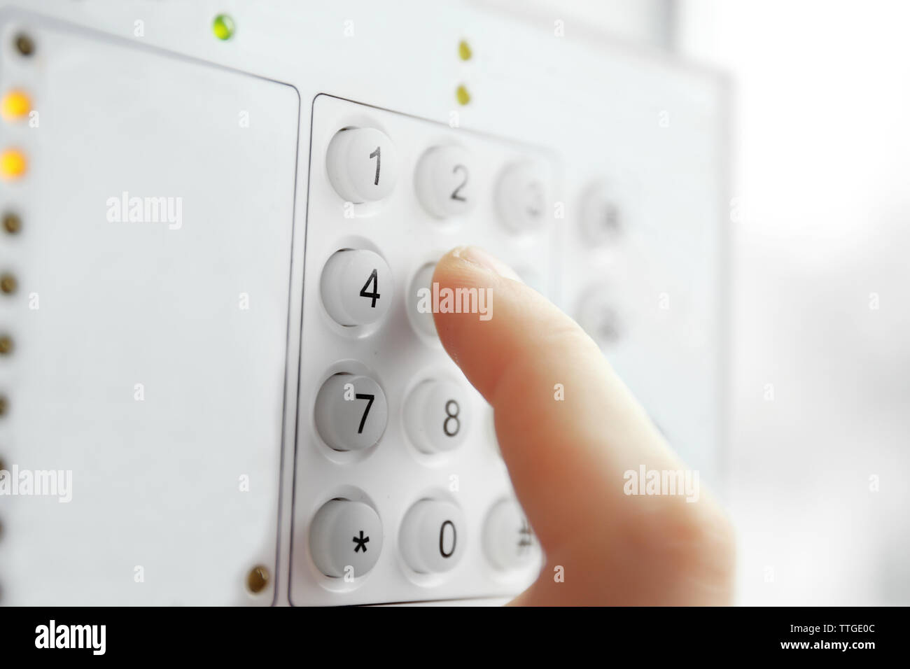 Security alarm keypad with male hand, closeup Stock Photo - Alamy
