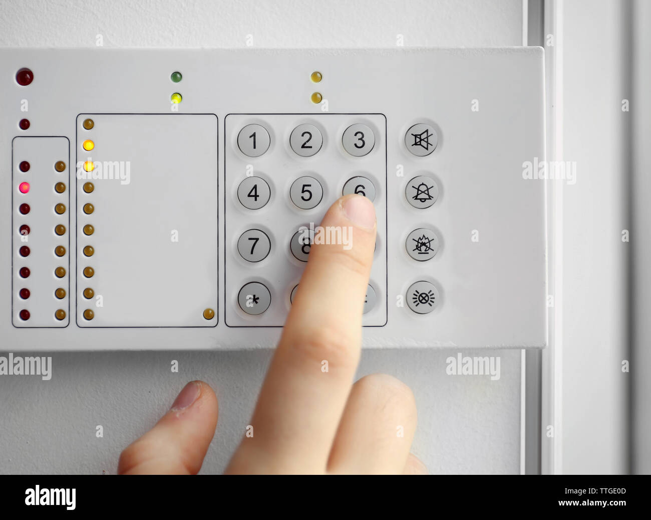 Security alarm keypad with male hand, closeup Stock Photo - Alamy