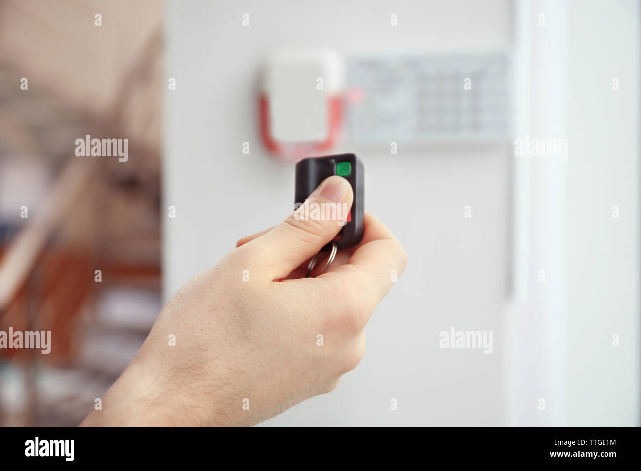 Security alarm keypad with male hand and button, closeup Stock Photo ...