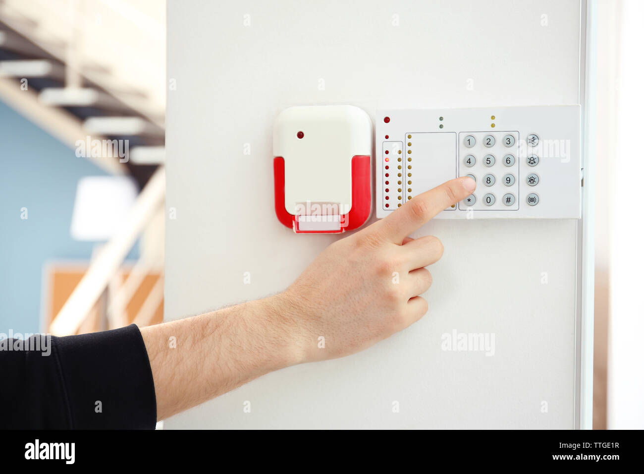Security alarm keypad with male hand, closeup Stock Photo - Alamy