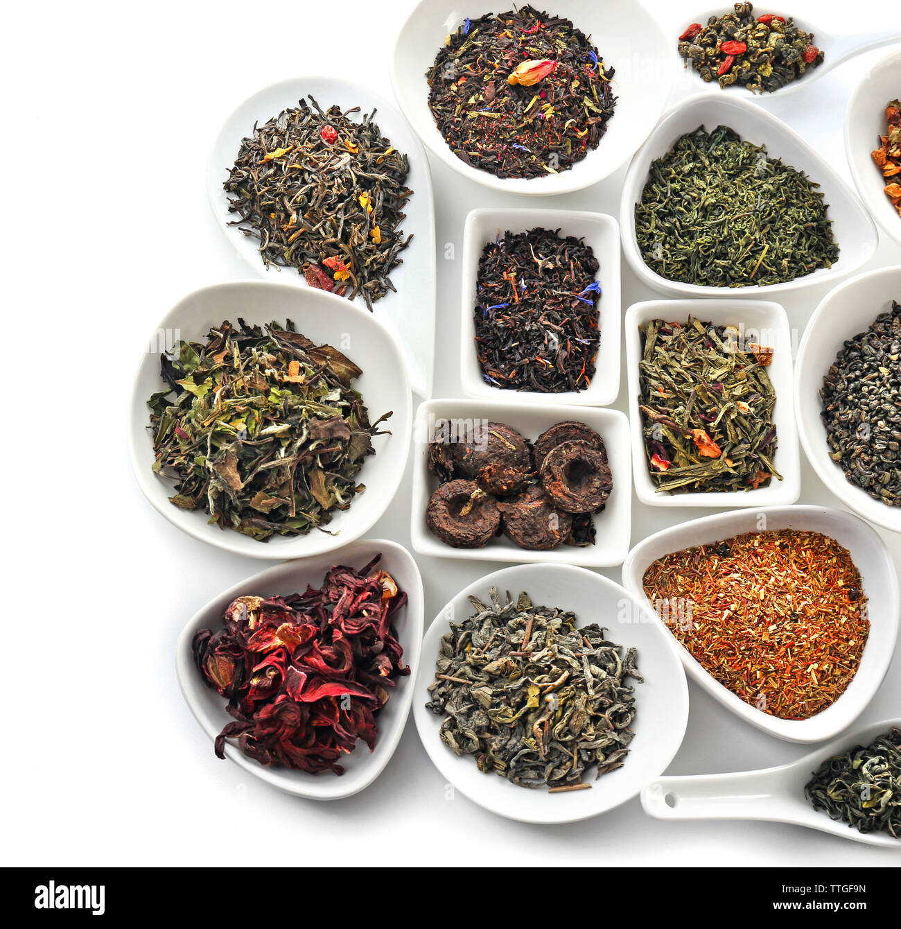 Variety of dry tea in bowls and spoons isolated on white Stock Photo ...