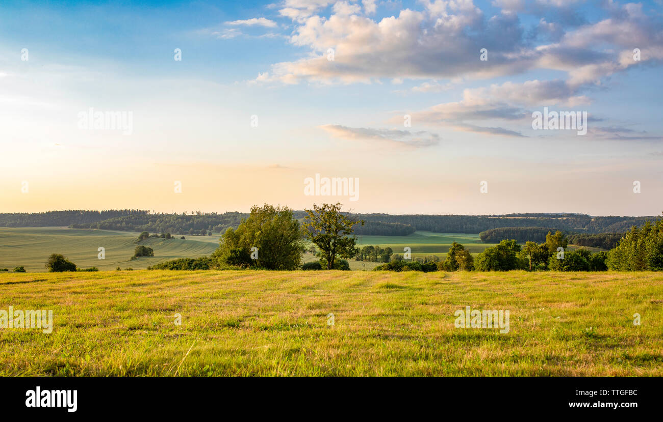 Meadows in Lower Silesia, white clouds formations on blue sky. Polish ...