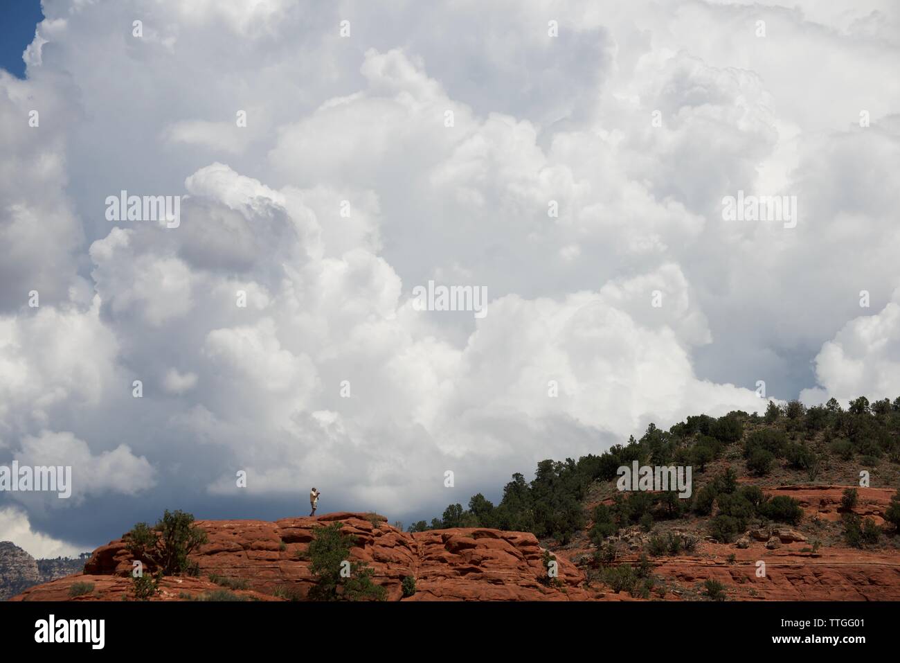 Person on lookout with dramatic sky Stock Photo - Alamy
