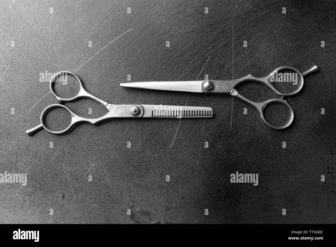 Professional metal scissors lying in two different positions on the ...