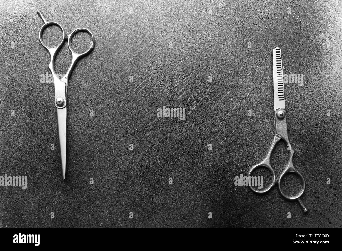 Professional metal scissors lying in two different positions on the ...