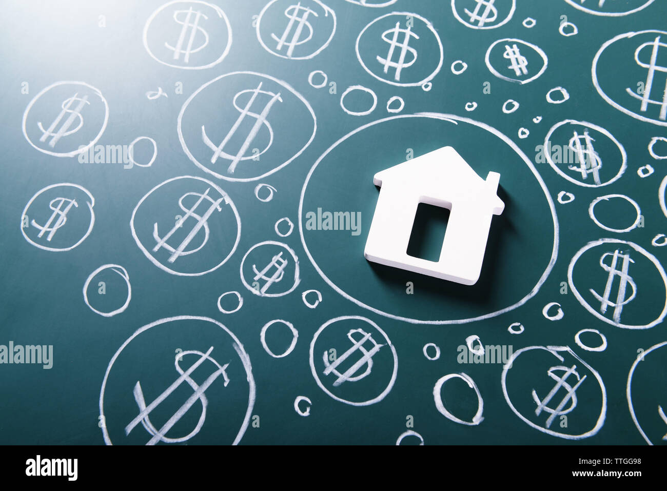 House figure and painted dollar symbols on chalkboard,closeup Stock ...