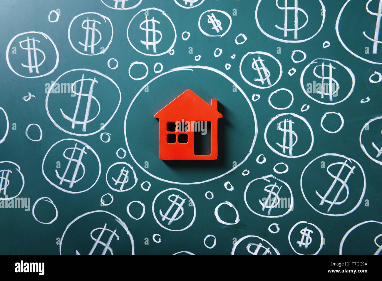 House figure and painted dollar symbols on chalkboard,closeup Stock ...