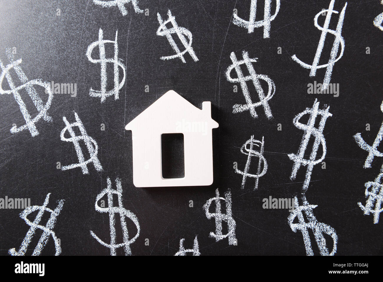House figure and painted dollar symbols on chalkboard,closeup Stock ...