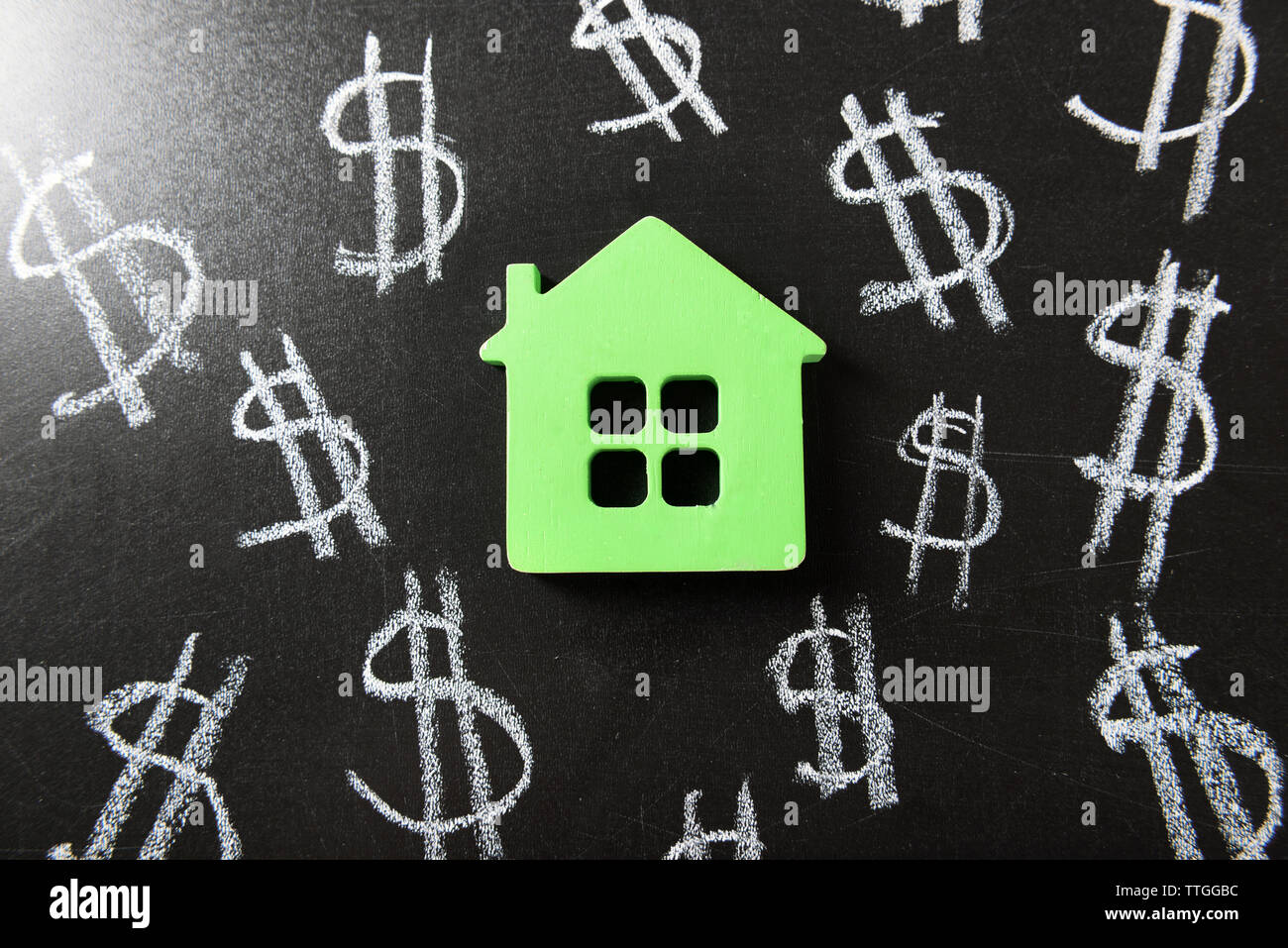 House figure and painted dollar symbols on chalkboard,closeup Stock ...