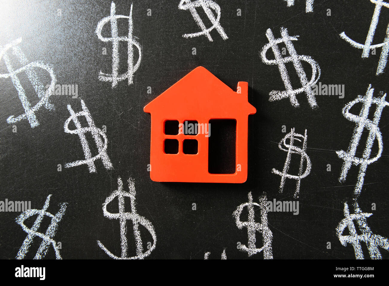 House figure and painted dollar symbols on chalkboard,closeup Stock ...