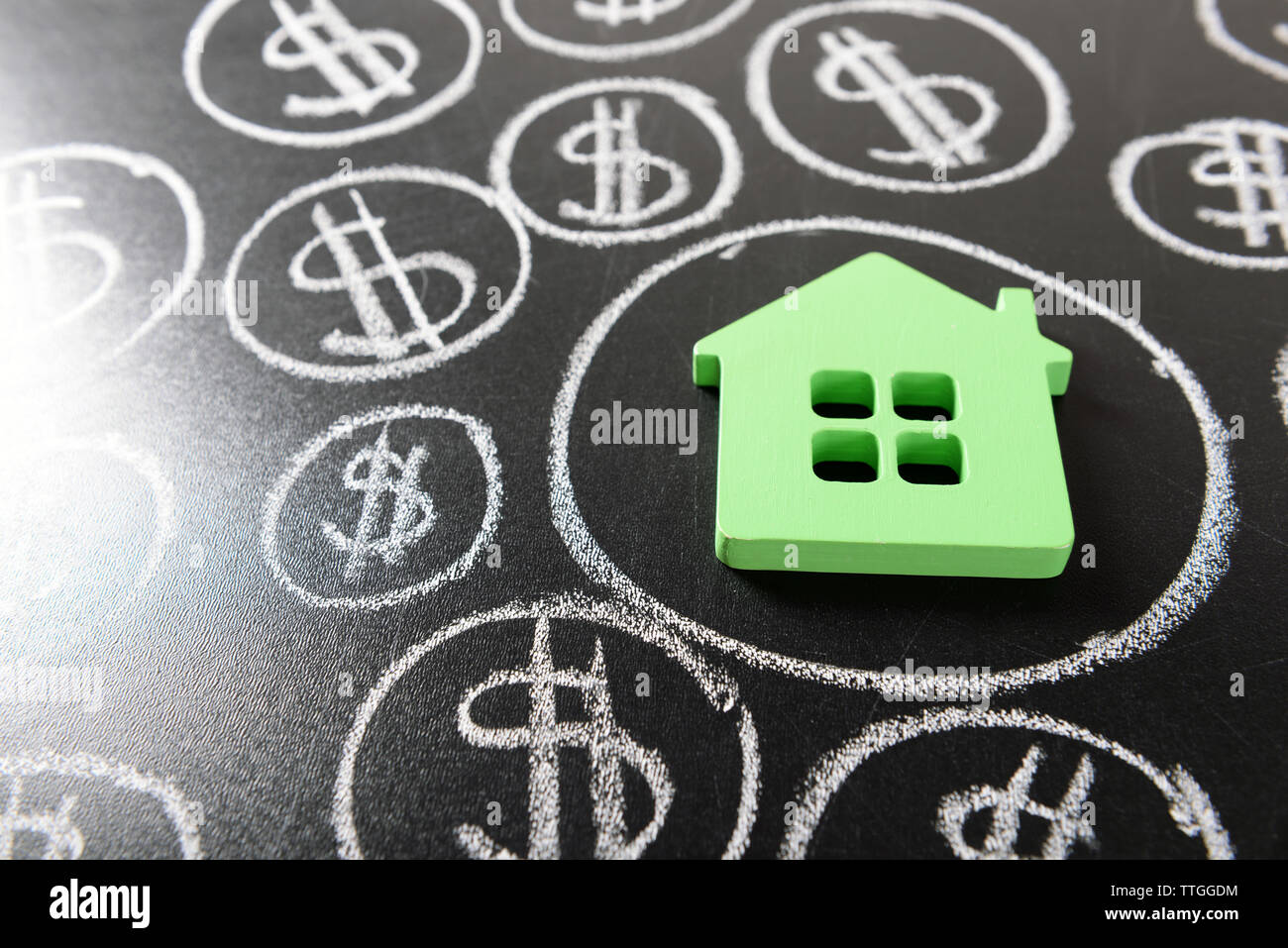 House figure and painted dollar symbols on chalkboard,closeup Stock ...