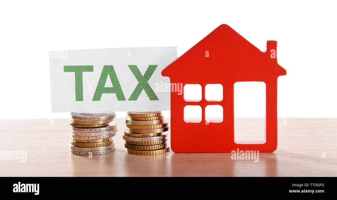 House figure, coins and tax sign, closeup Stock Photo - Alamy