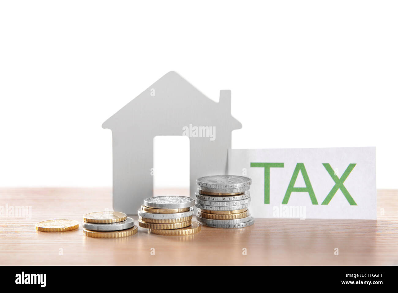 House figure, coins and tax sign, closeup Stock Photo - Alamy