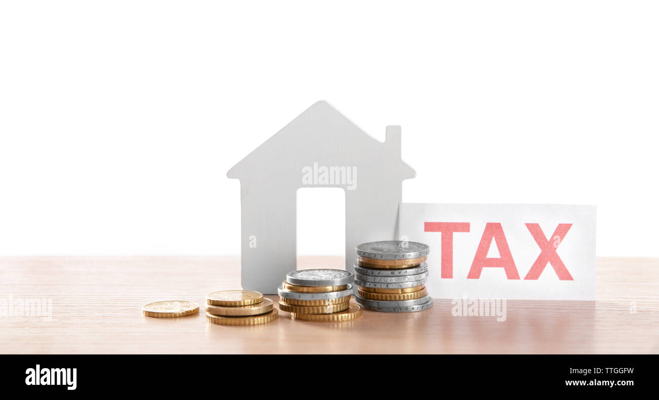 House figure, coins and tax sign, closeup Stock Photo - Alamy