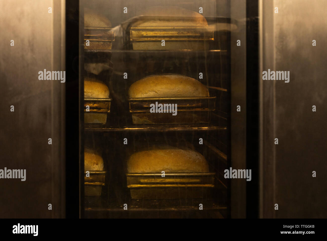 Loaves of bread bake in a rotating oven Stock Photo - Alamy