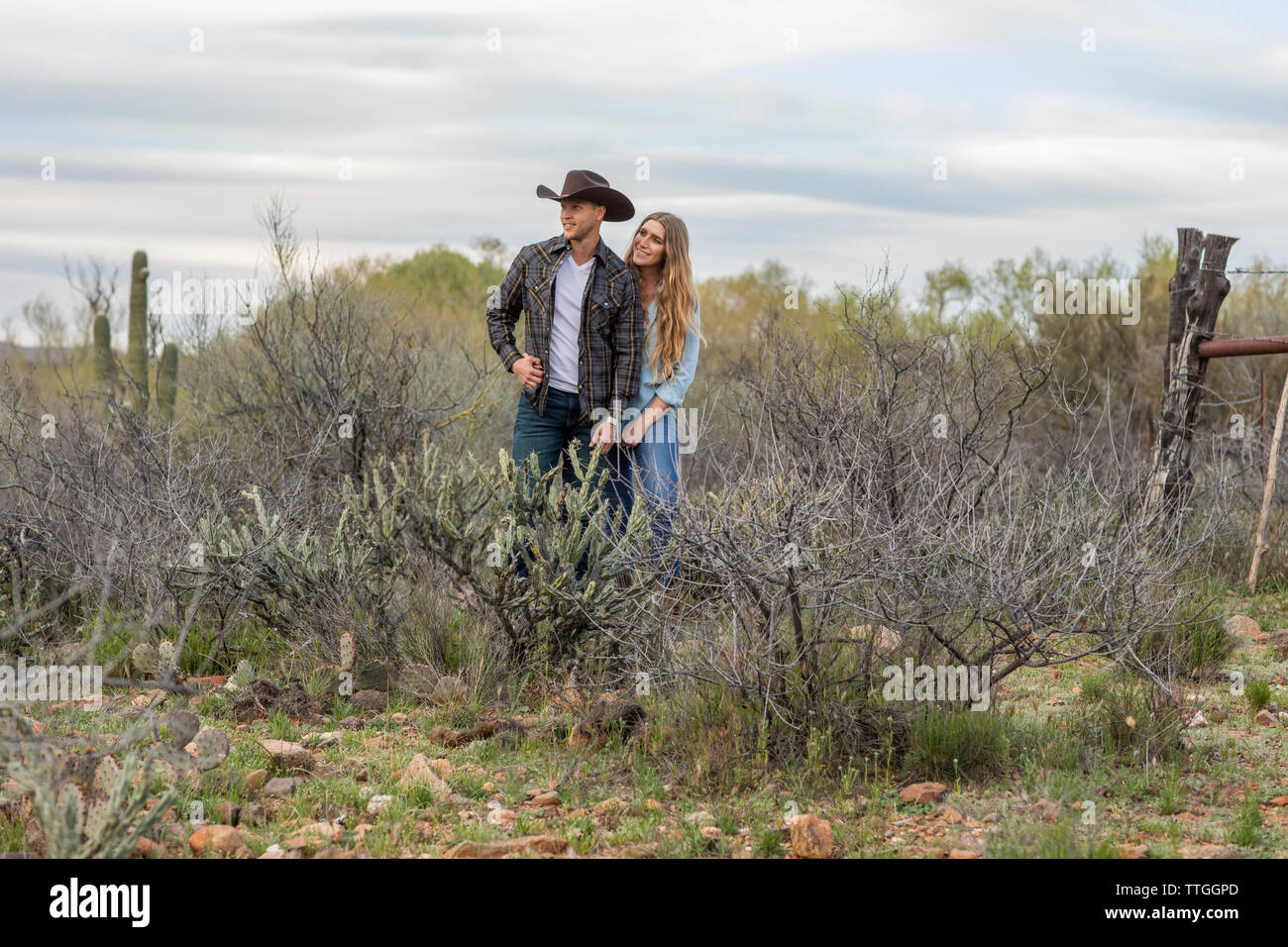 Western wear young married couple on desert ranch Stock Photo - Alamy