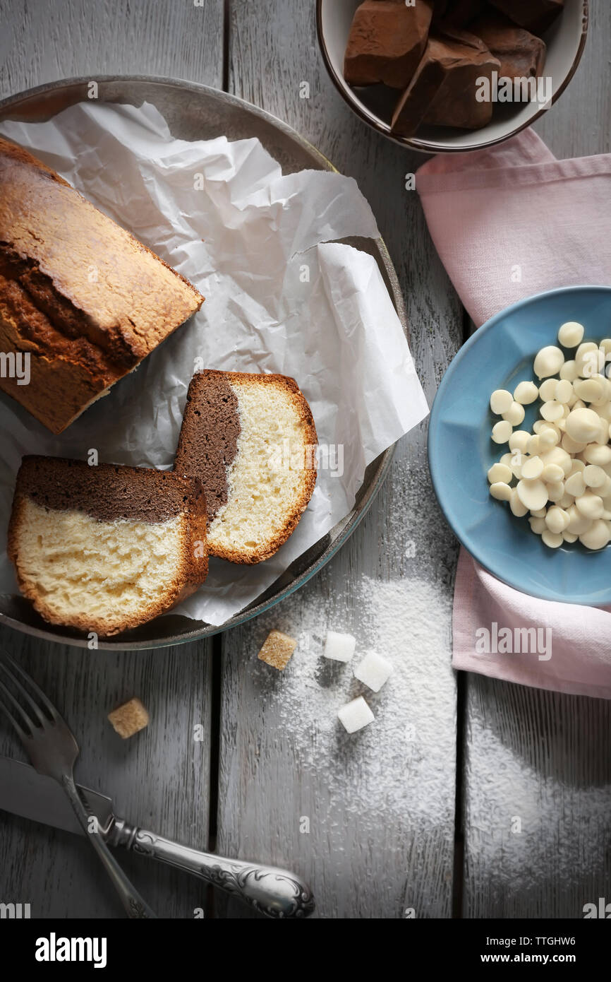 Composition of tasty cake with chocolate morsels and sugar on grey ...