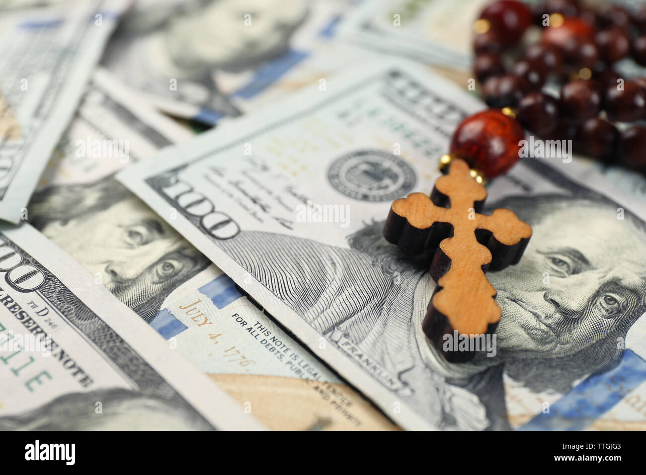 Rosary beads on money background, closeup Stock Photo - Alamy