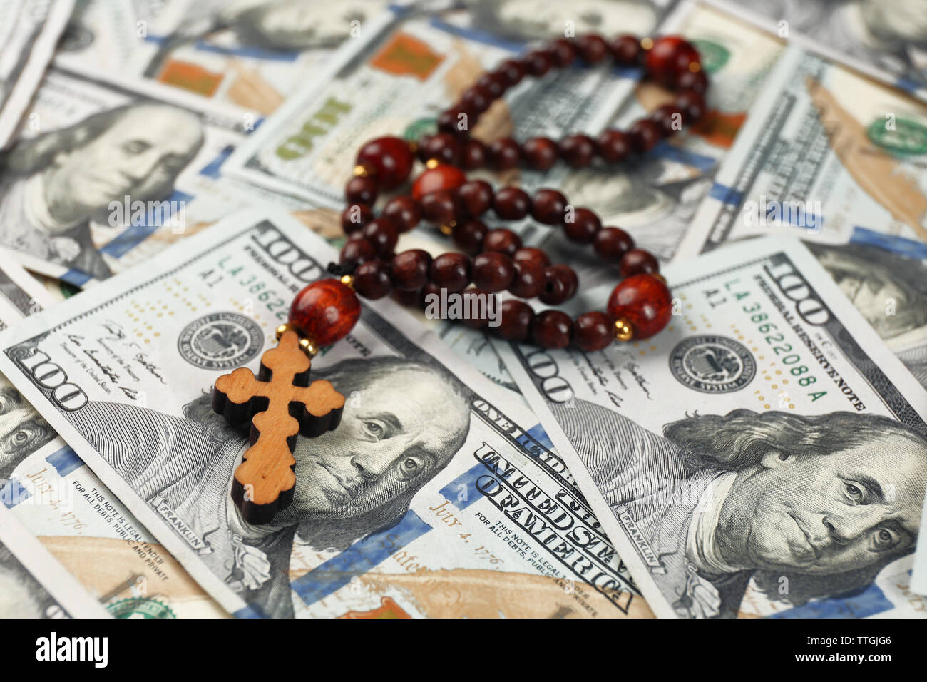 Rosary beads on money background, closeup Stock Photo - Alamy