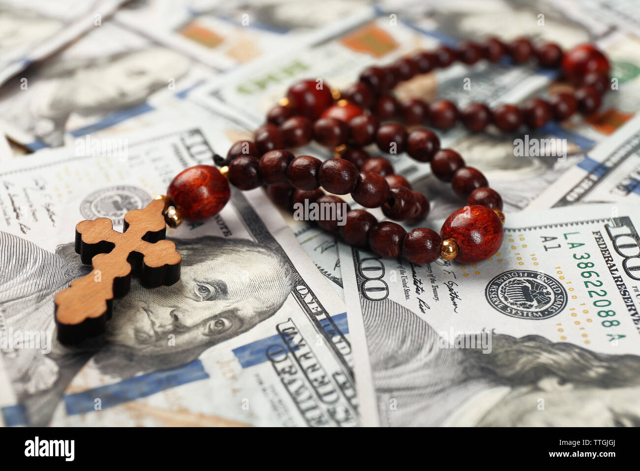 Rosary beads on money background, closeup Stock Photo - Alamy