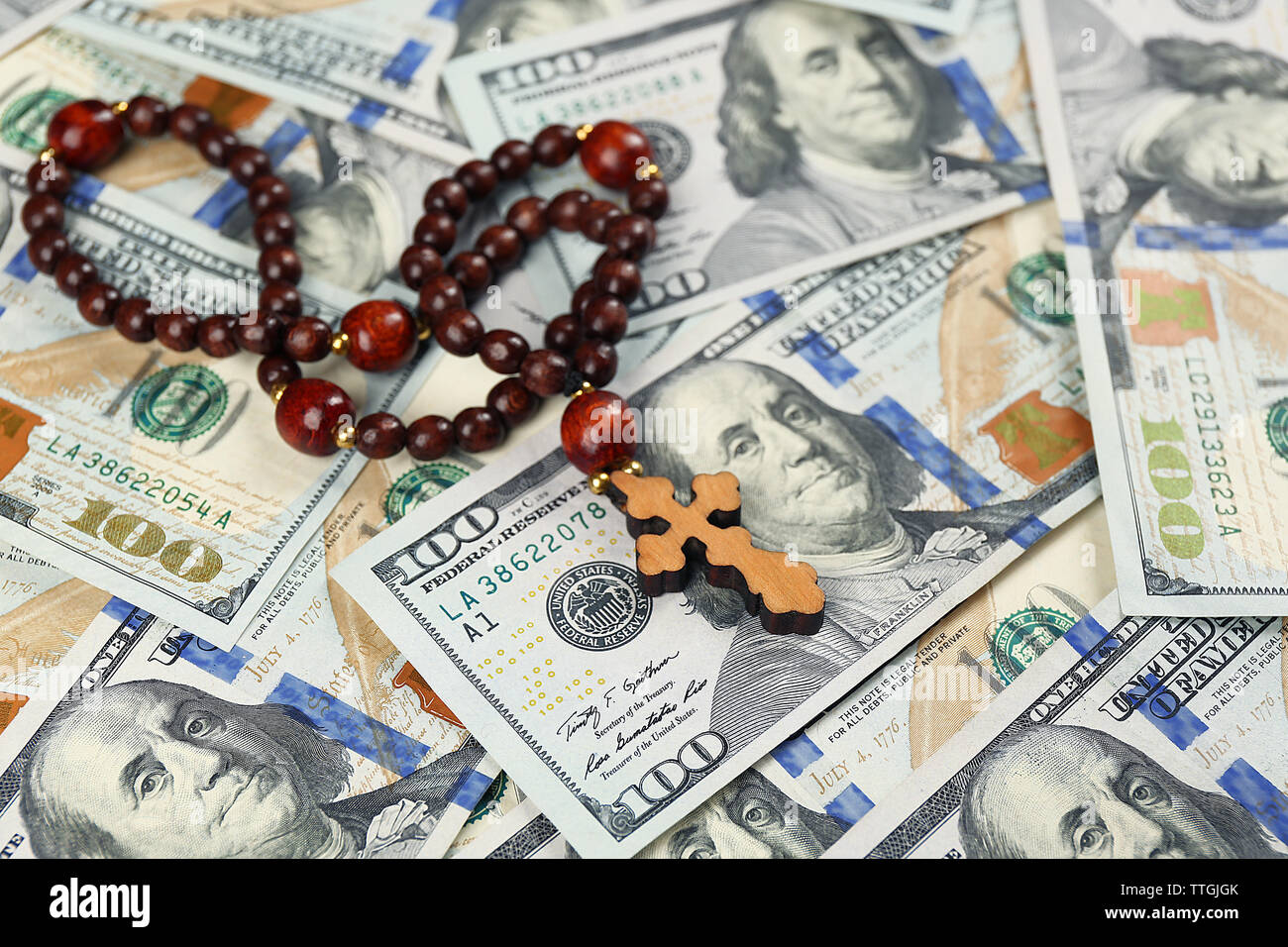 Rosary beads on money background, closeup Stock Photo - Alamy