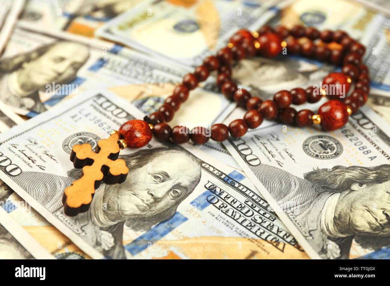 Rosary beads on money background, closeup Stock Photo - Alamy