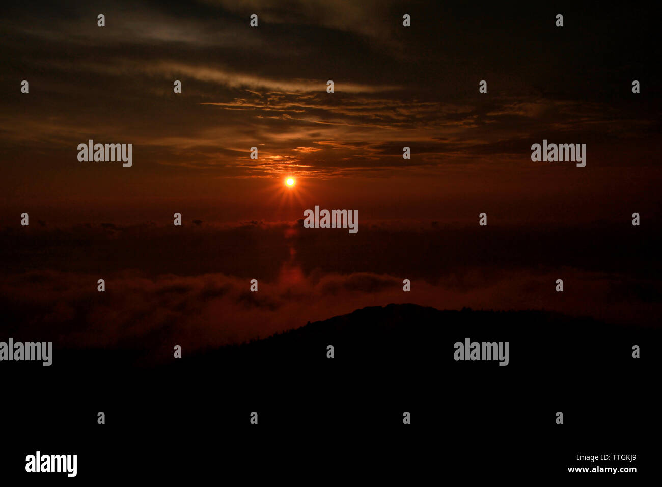 Beautiful structure of clouds on sky, mountain landscape with dense fog ...