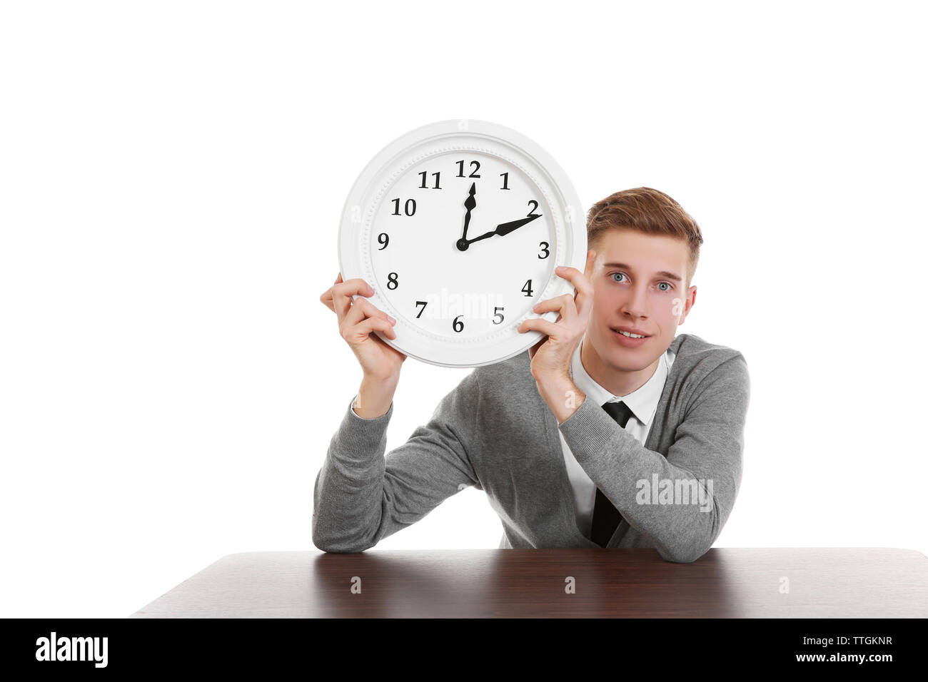 Handsome young man holding clock, isolated on white Stock Photo - Alamy