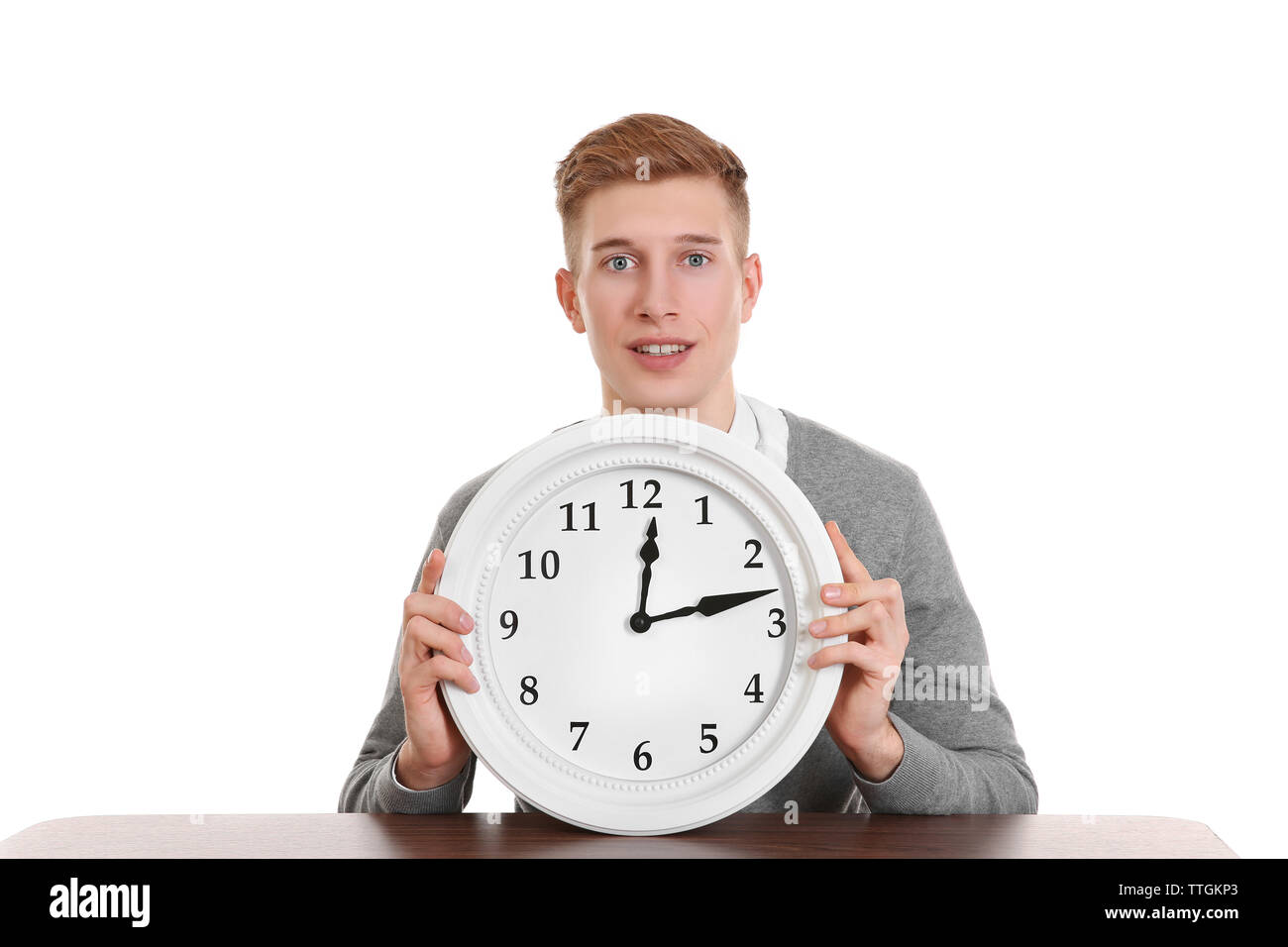 Handsome young man holding clock, isolated on white Stock Photo - Alamy
