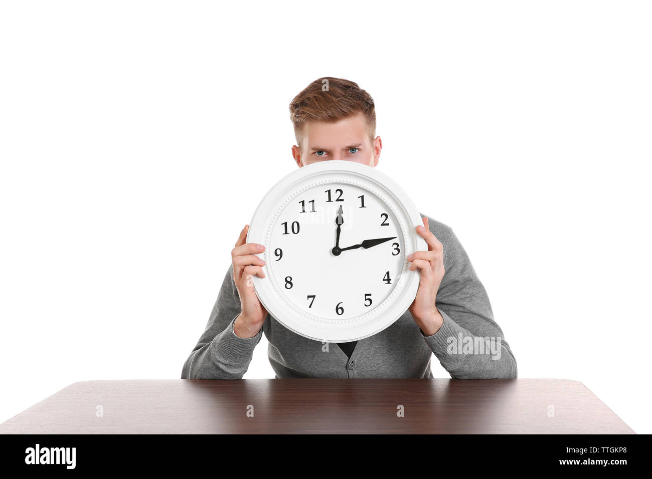 Young handsome man holding clock, isolated on white Stock Photo - Alamy