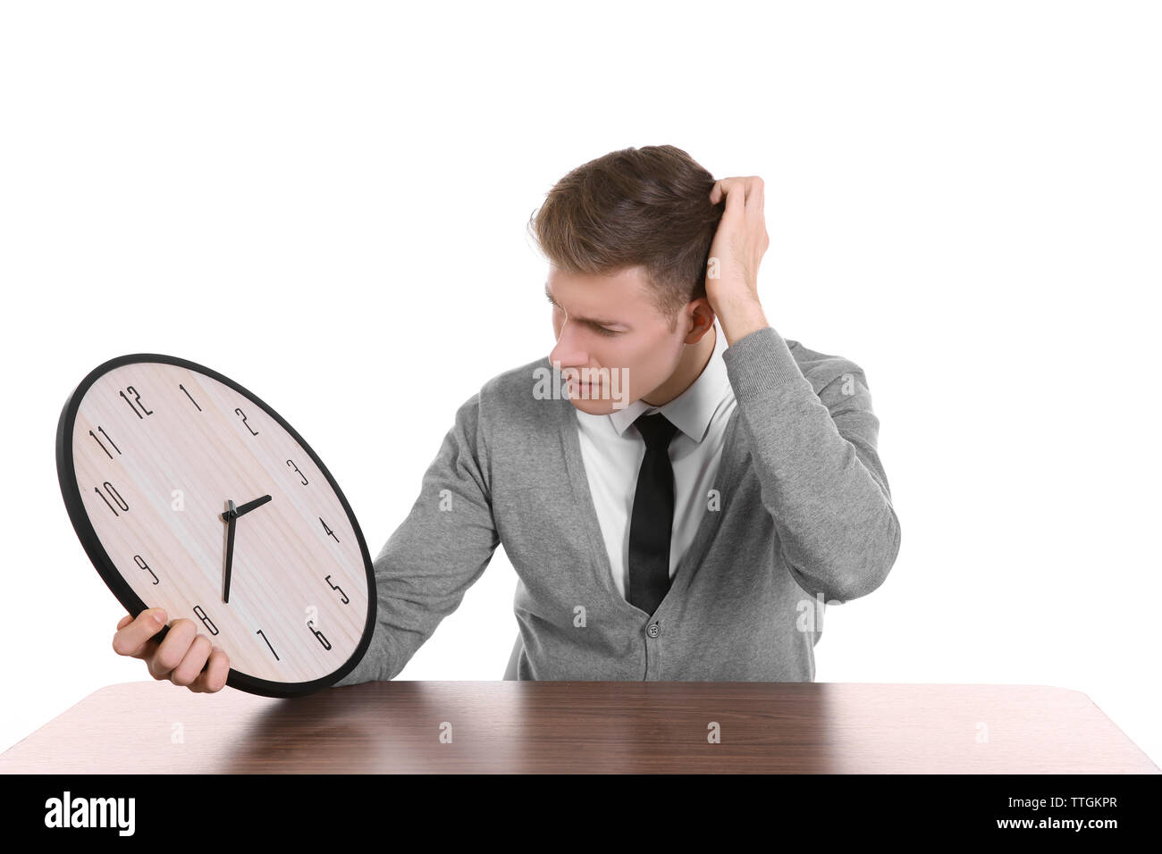 Handsome young man holding clock, isolated on white Stock Photo - Alamy
