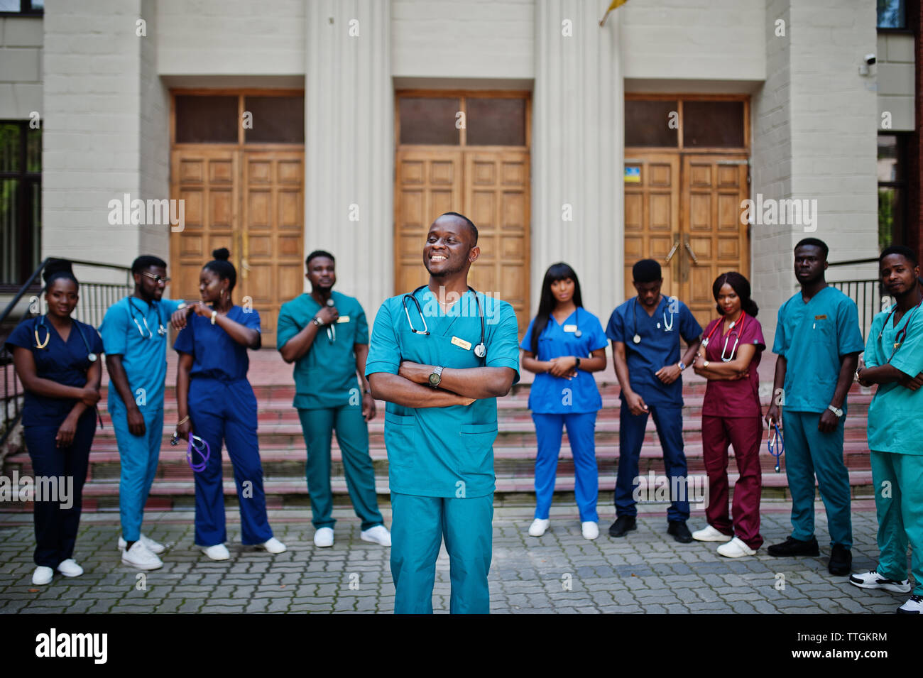 Group of african medical students posed outdoor against university door ...