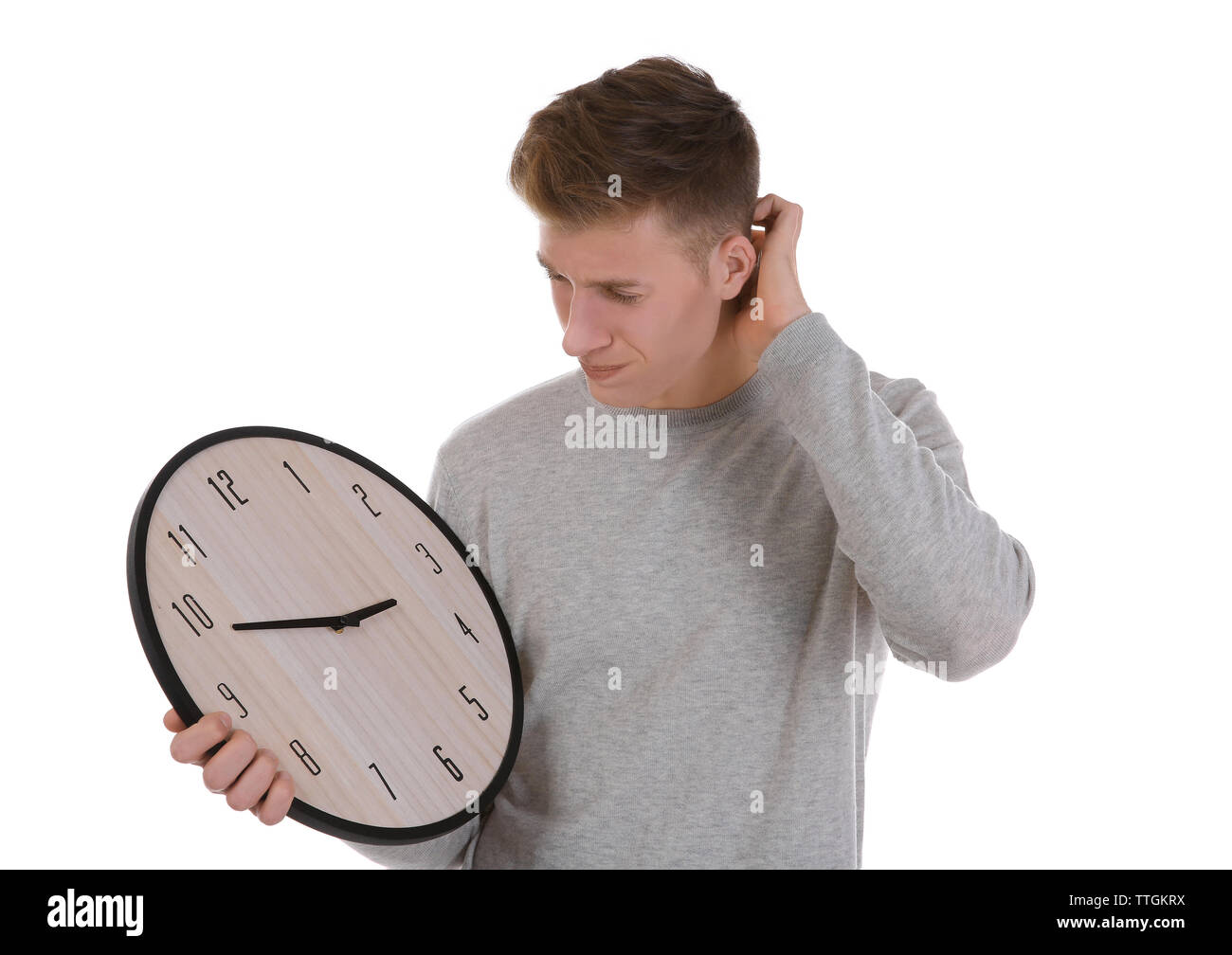 Handsome young man holding clock, isolated on white Stock Photo - Alamy